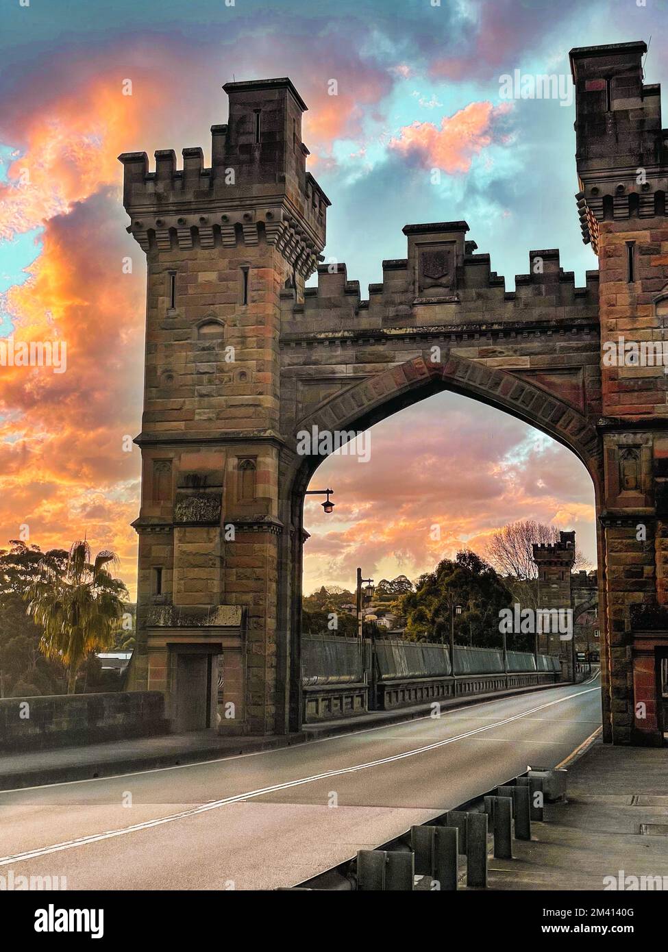 A vertical view of the Long Gully Bridge under colorful cloudy dusk sky ...