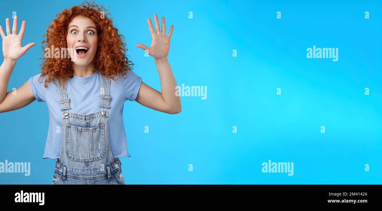 Excited crazy playful funny redhead curly emotive girl yelling carefree ...