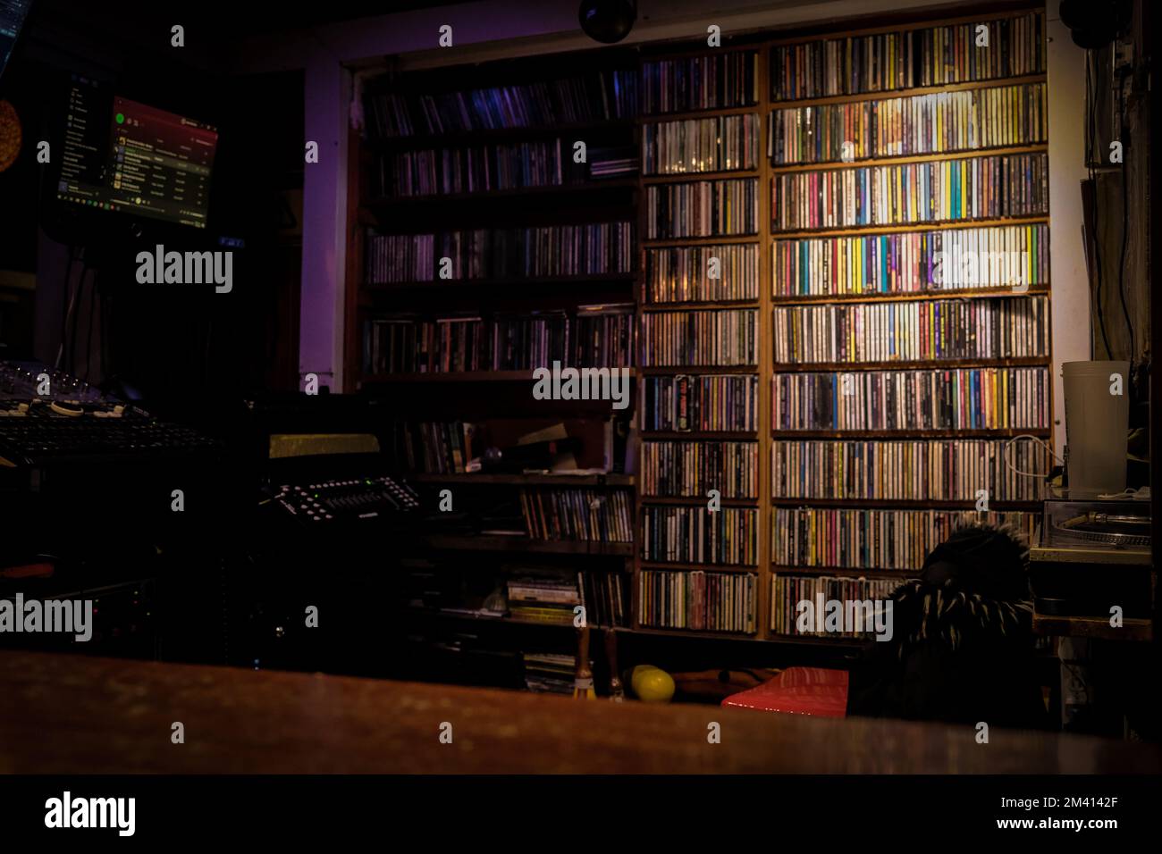 An interior of vinyl shelves in a nightclub in dim lighting Stock Photo ...