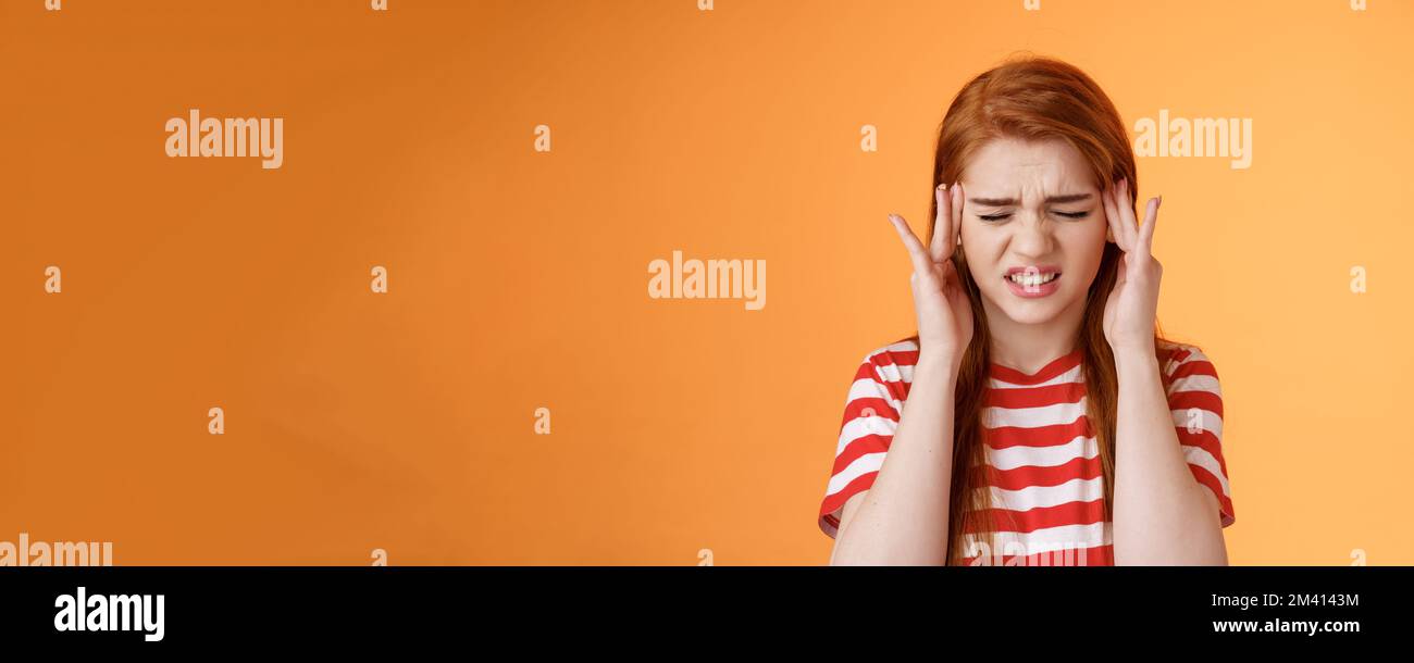 Dizzy uneasy cute redhead female student suffering huge headache ...