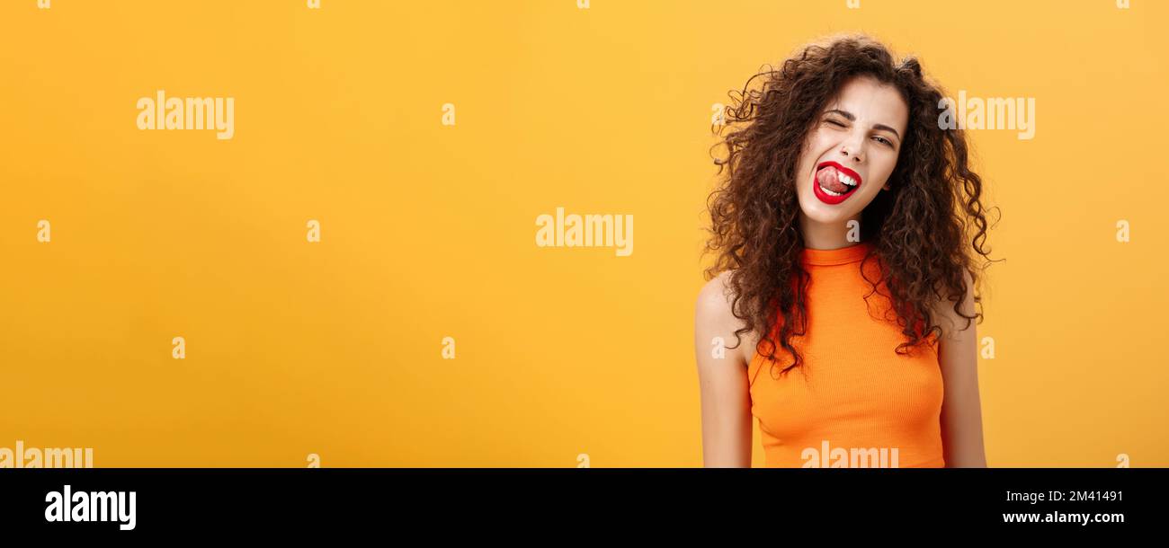 Portrait of upbeat playful and stylish caucasian girl with curly hair ...
