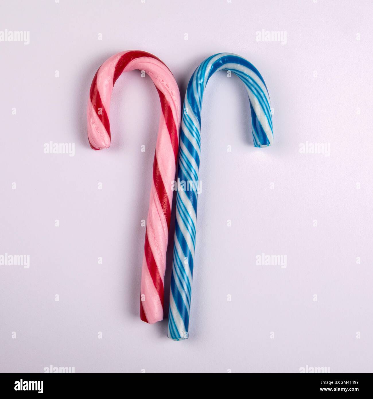 Christmas composition. Red and blue candy cane on a white background ...