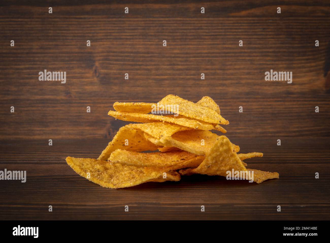 Corn chips nachos on wood texture background Stock Photo - Alamy