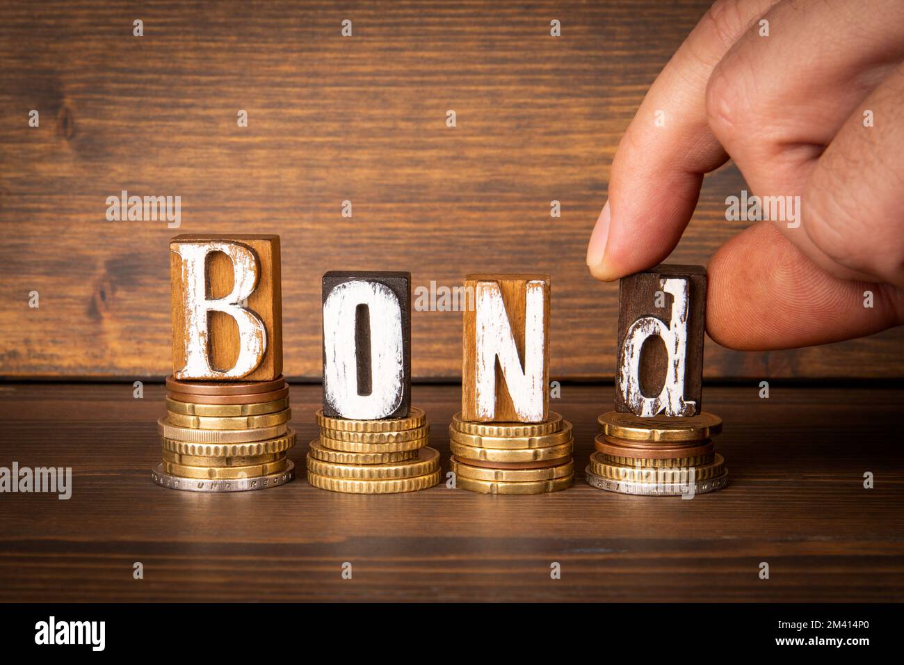 BOND. Money and letters of the alphabet on a dark wooden background ...