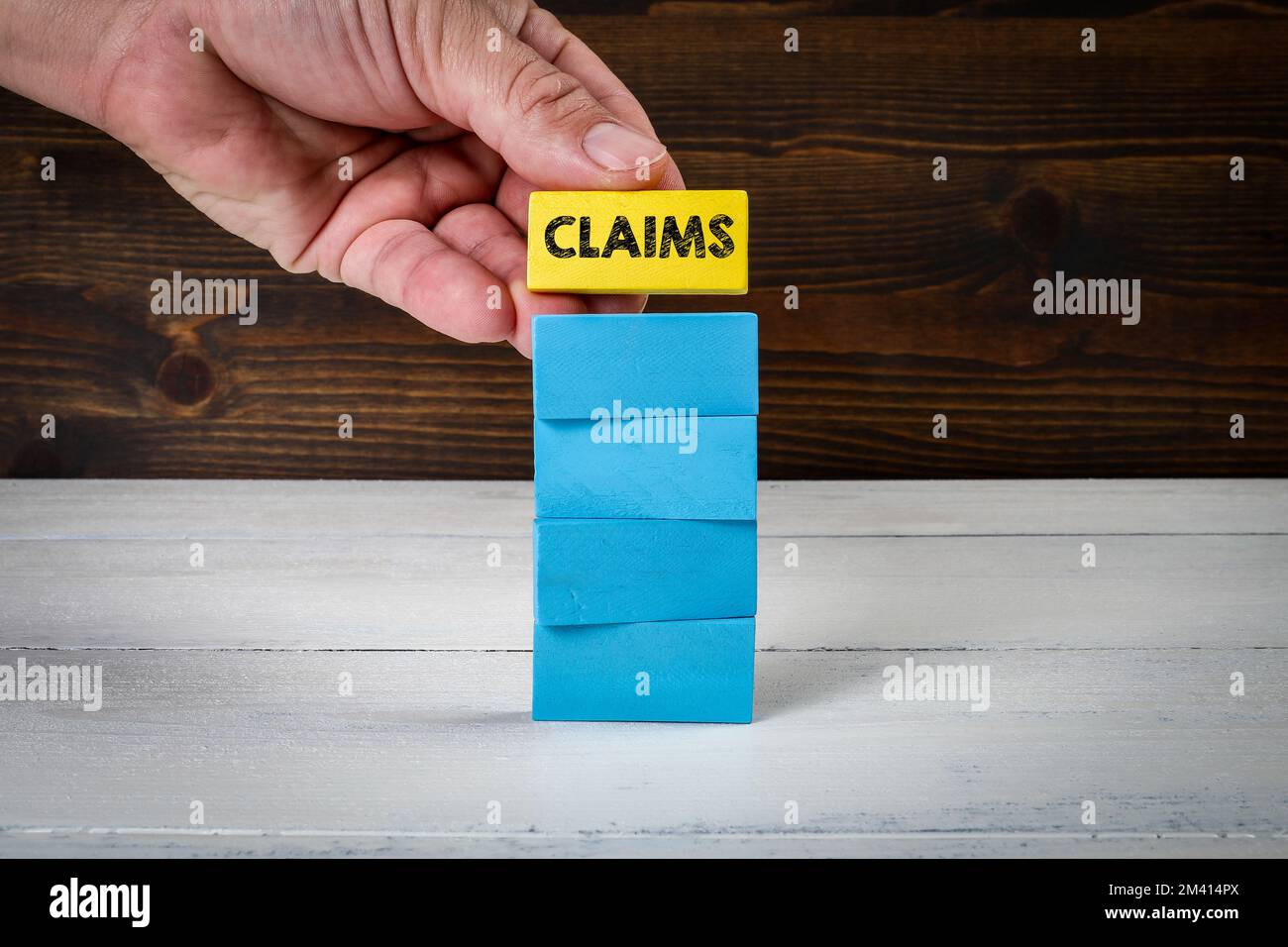 Claims. Colorful blocks in a pile on a dark and light wooden background ...