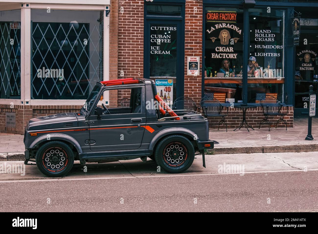 A Suzuki parked against a brick building in a historic district of ...