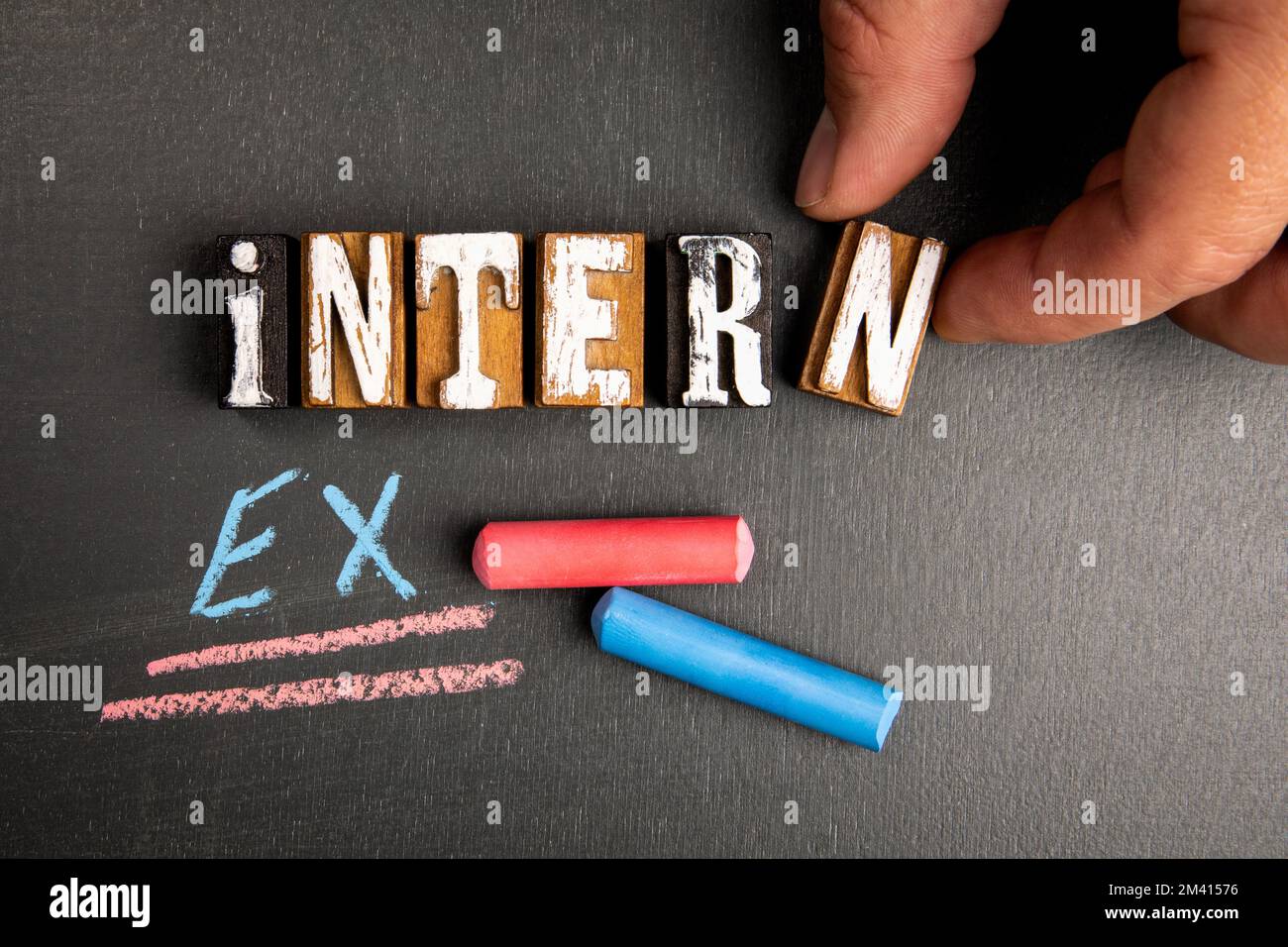 Intern and Extern concept. Wooden letter blocks on blackboard ...