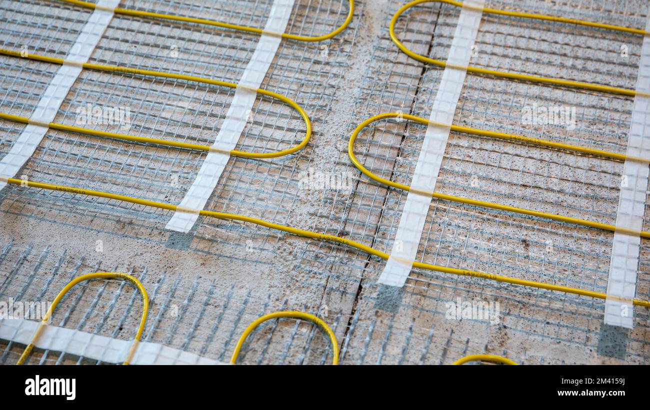 Electric warm floor laying. Cable and fiberglass mesh. Horizontal Stock ...