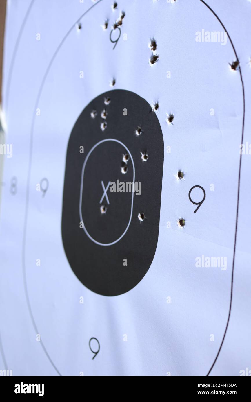 A shooting target paper with holes Stock Photo - Alamy