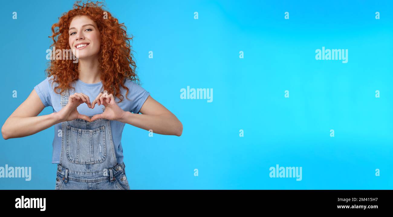 Sassy confident good-looking modern redhead curly woman raise head ...