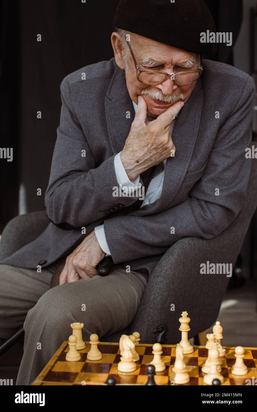 ʼSenior man thinking about his next move in a game of chess Stock Photo ...