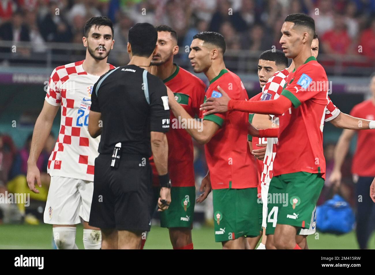 Morocco players around HAKIMI Achraf (withte, MAR) press referee AL ...