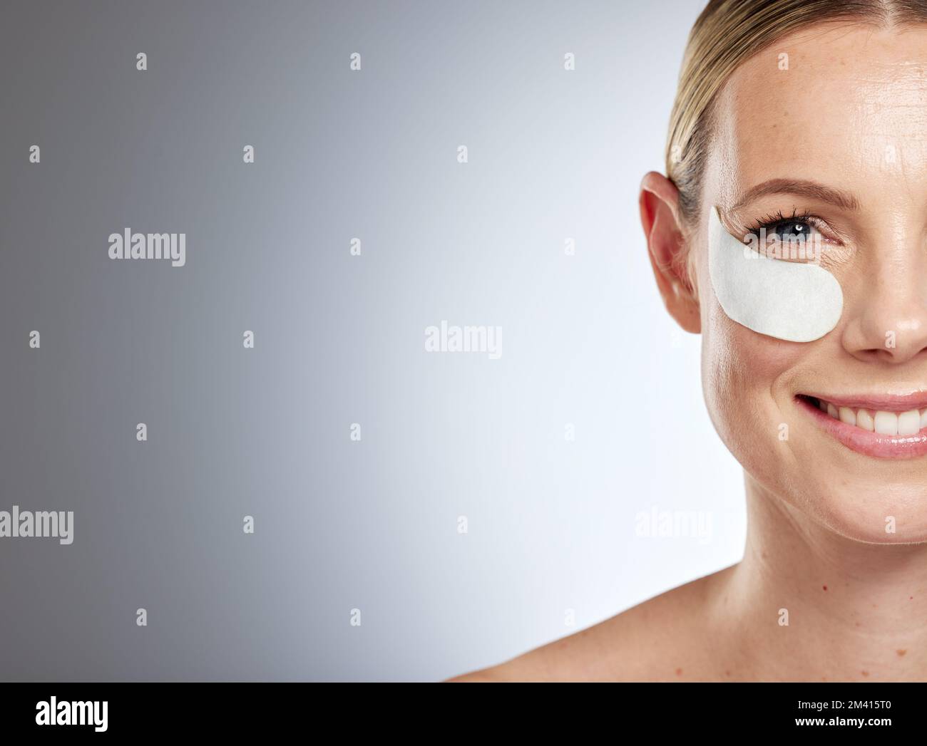 Face, eye mask and mockup with a model woman in studio on gray ...