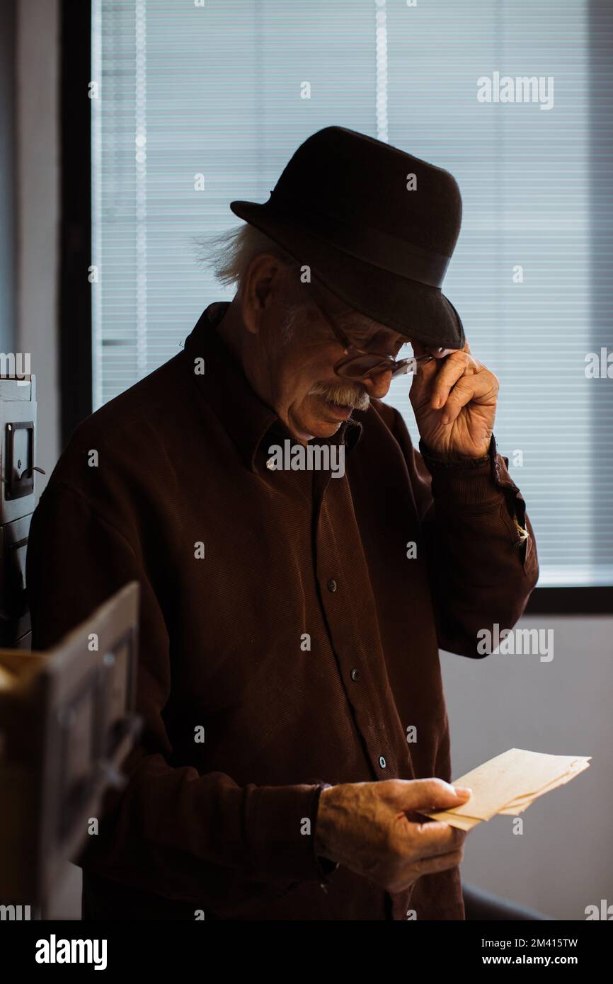 Senior male archivist searching for catalogs Stock Photo - Alamy