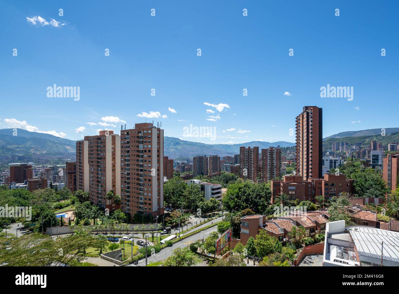 An aerial view of Medellin city with high buildings and green nature on ...