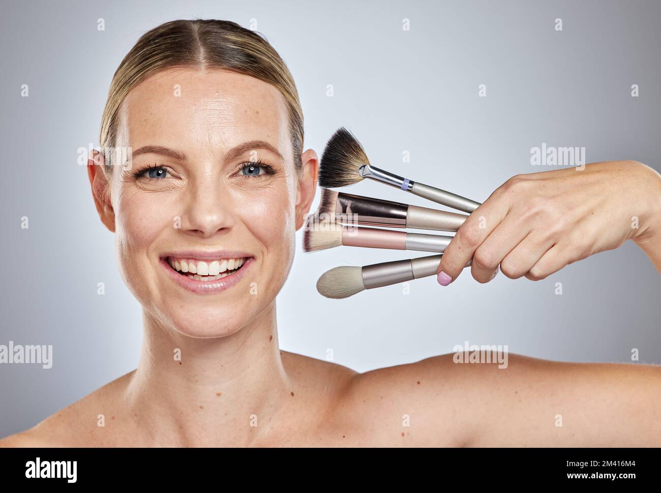 Woman, makeup brushes and portrait smile for cosmetics, beauty or ...