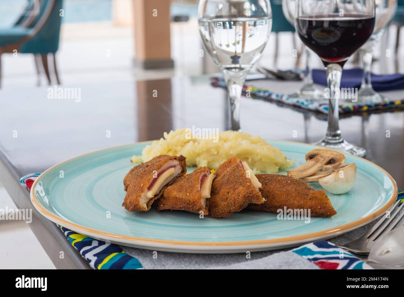 Stuffed chicken panne a la carte meal with mushrooms and mashed potato ...