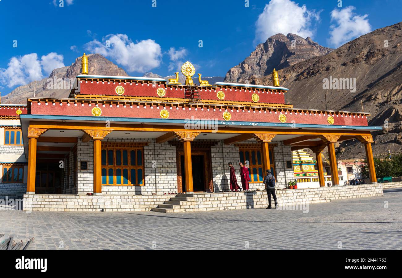 The Buddhist monks entering the Tabo Monastery with big mountains and ...