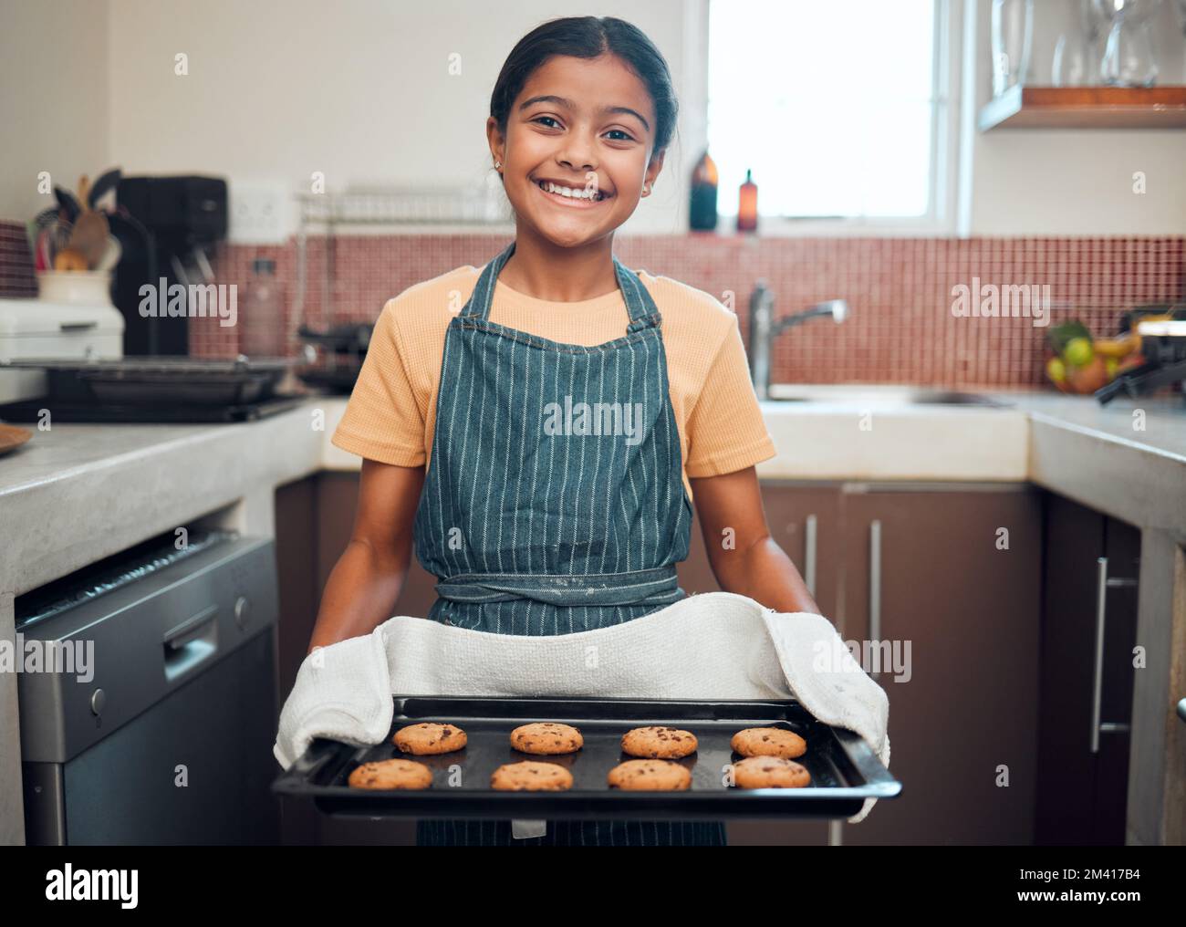Baking, cookies and girl portrait happy about food, learning and youth ...