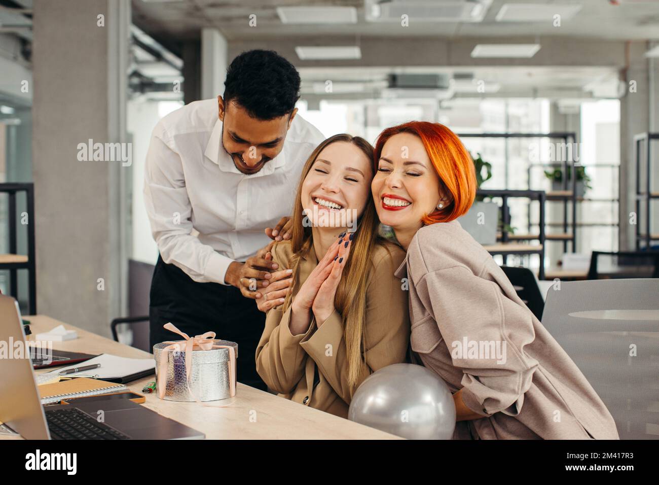 Happy employees surprising colleague hi-res stock photography and ...