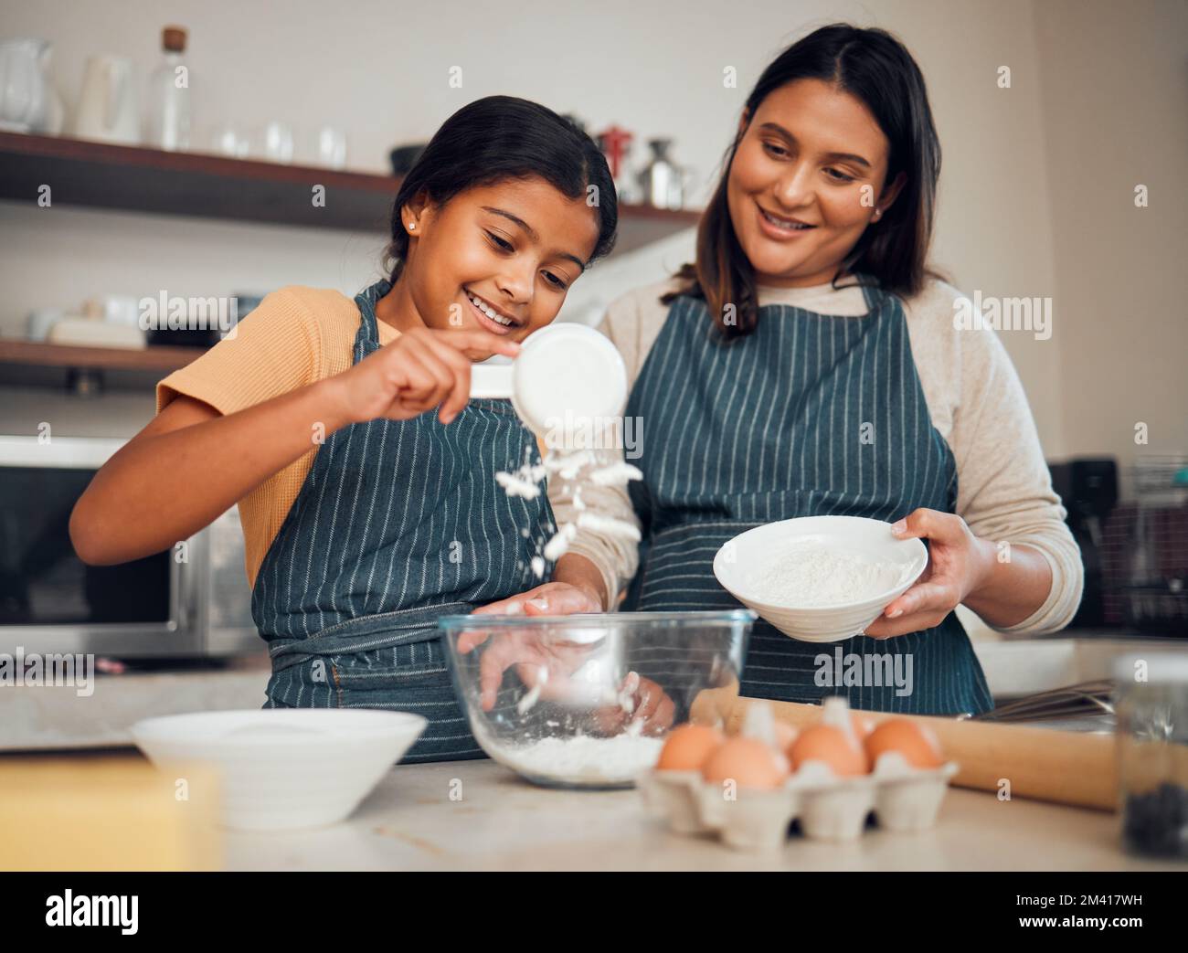 Baking, family and children with a mother and daughter learning about ...