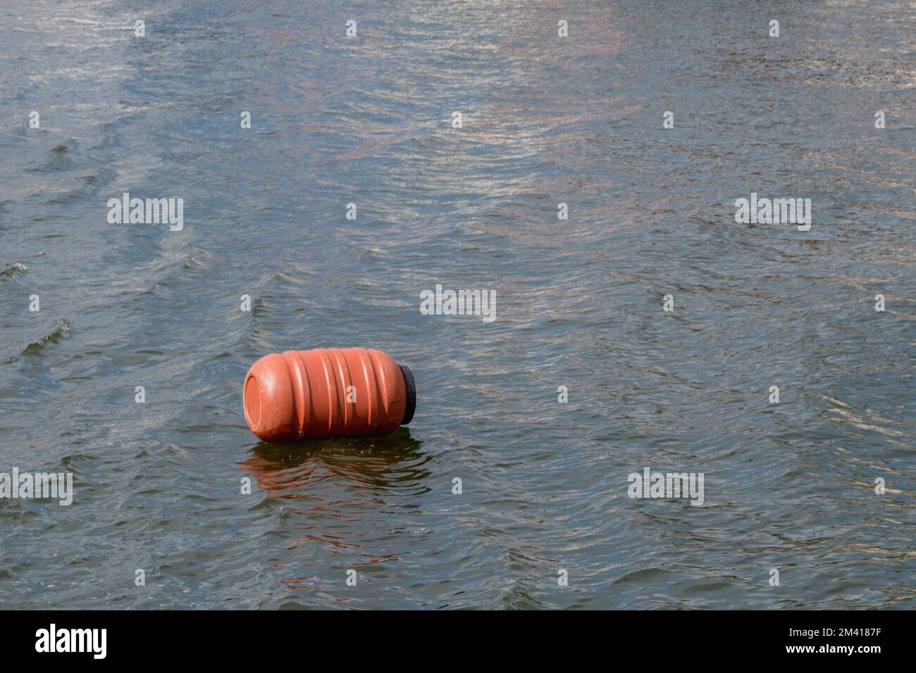 Plastic barrel, buoy in open water. water line border Stock Photo - Alamy