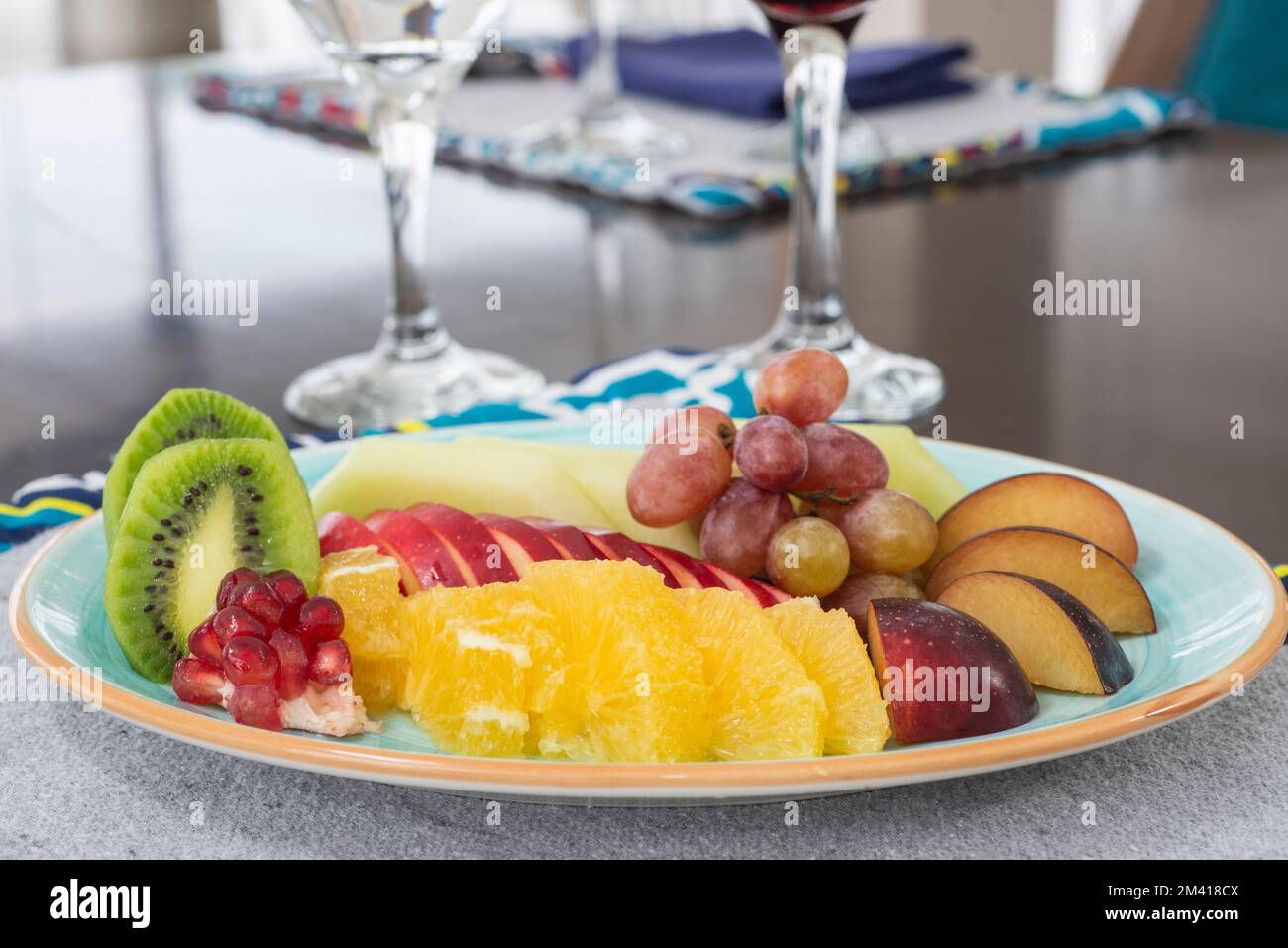 Selection of fresh fruit platter on a plate at restaurant table setting ...