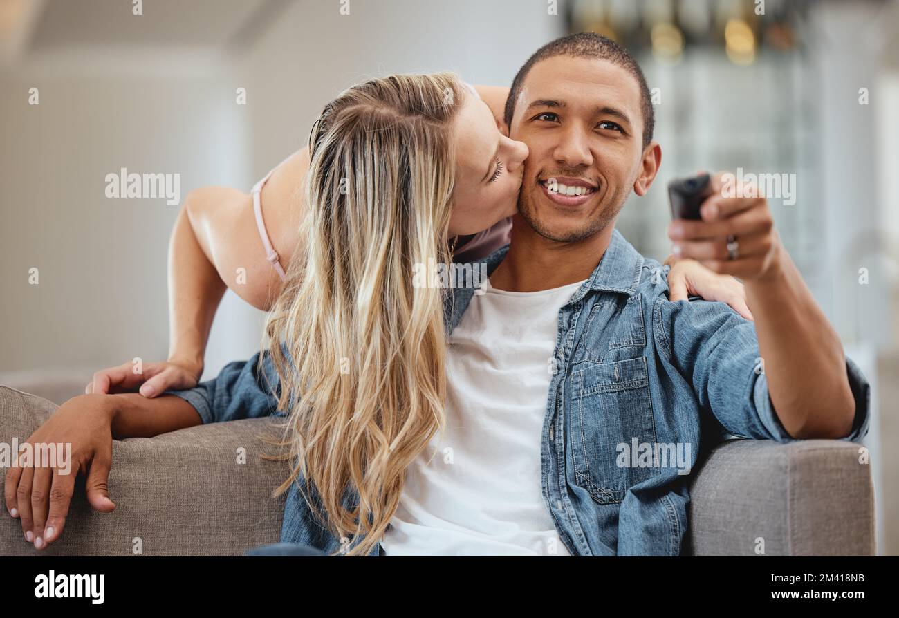 Couple, sofa and woman with cheek kiss for man, partner or husband with ...
