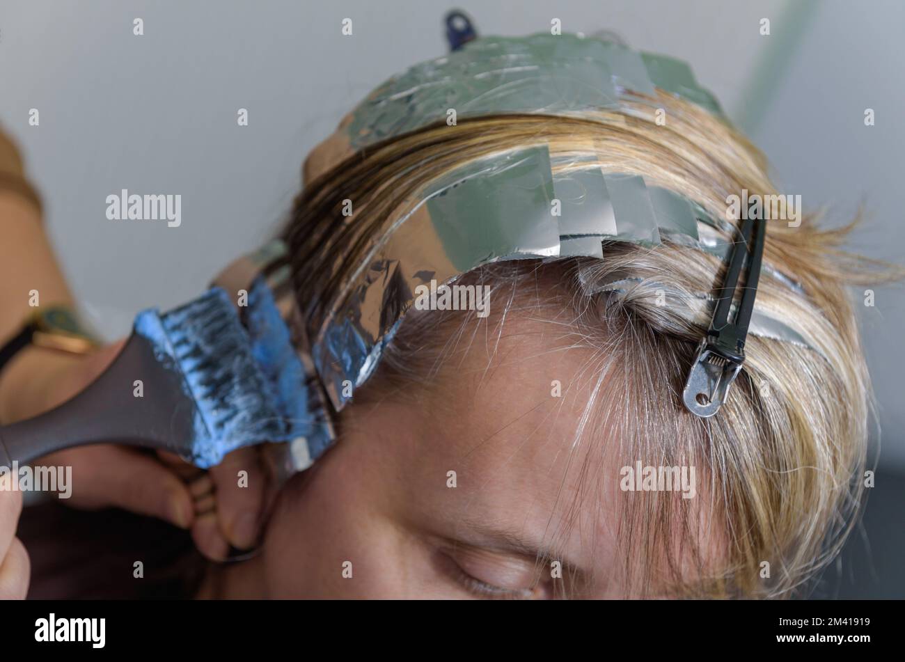 hair coloring process. use of foil. selected focus. hair texture. close ...