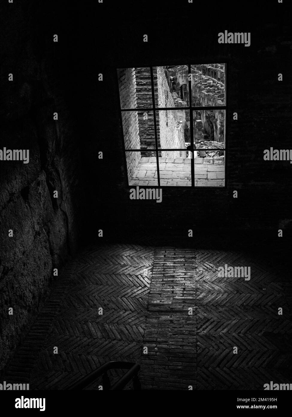 A black and white view of a light through windows in Coliseum in Rome ...