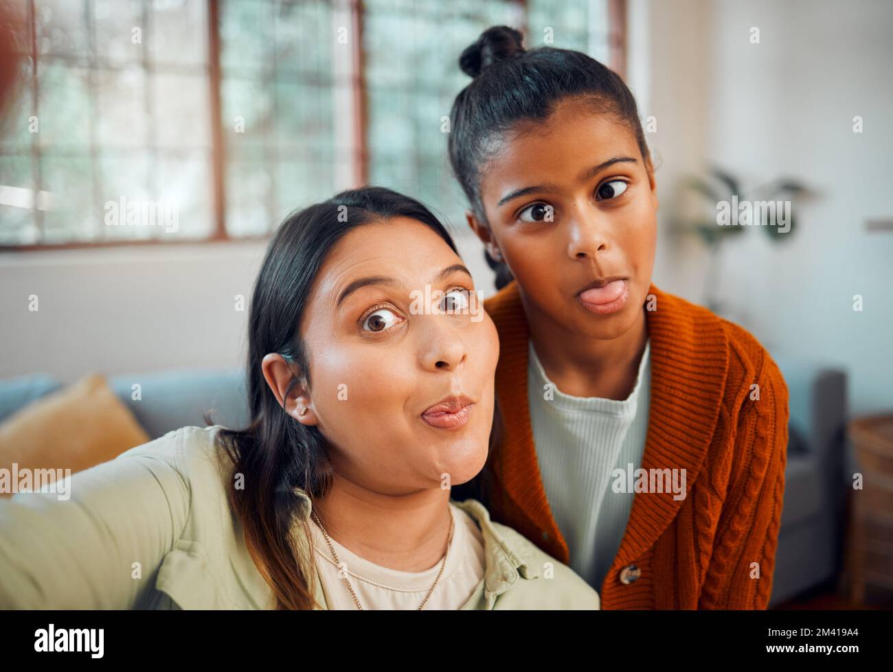 Selfie Mother And Daughter With Funny Comic Face And Bonding In Home