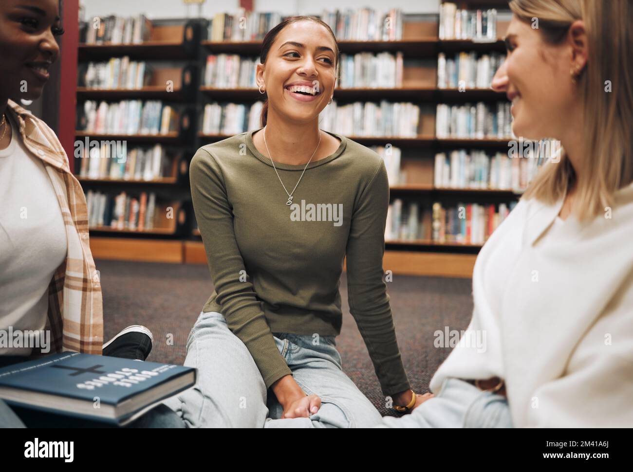 Student, friends and book discussion in library with smile for ...