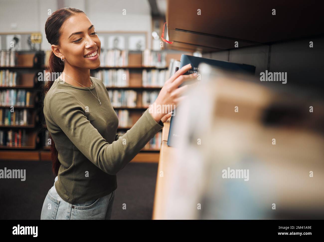 Student search bookshelf for books in library for education, knowledge ...