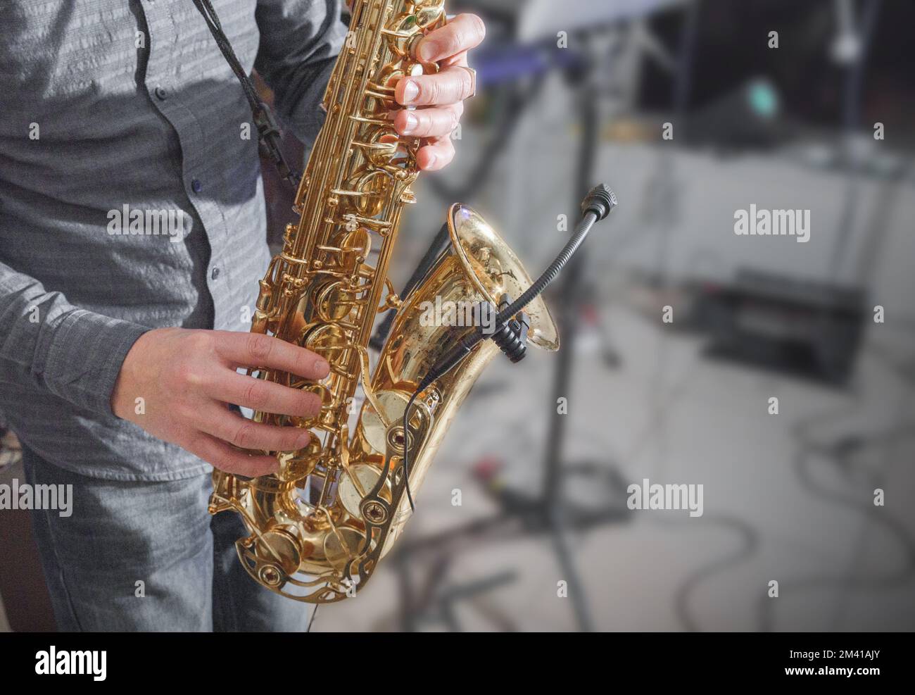 Saxophone playing. Hands of a man playing the saxophone. Dark ...