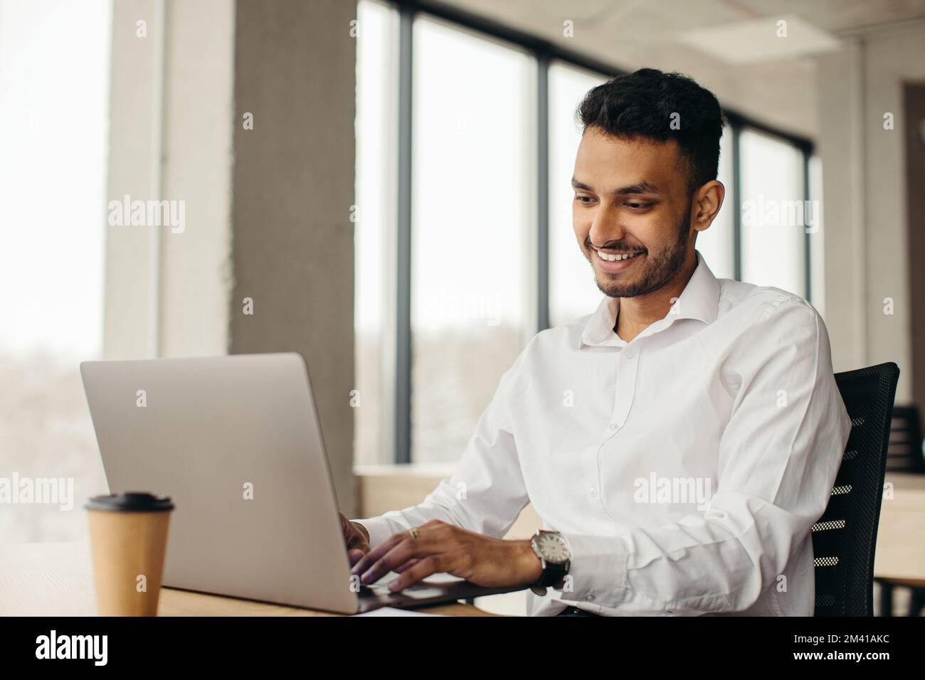 Young hindu businessman at workplace with laptop. Office work Stock ...