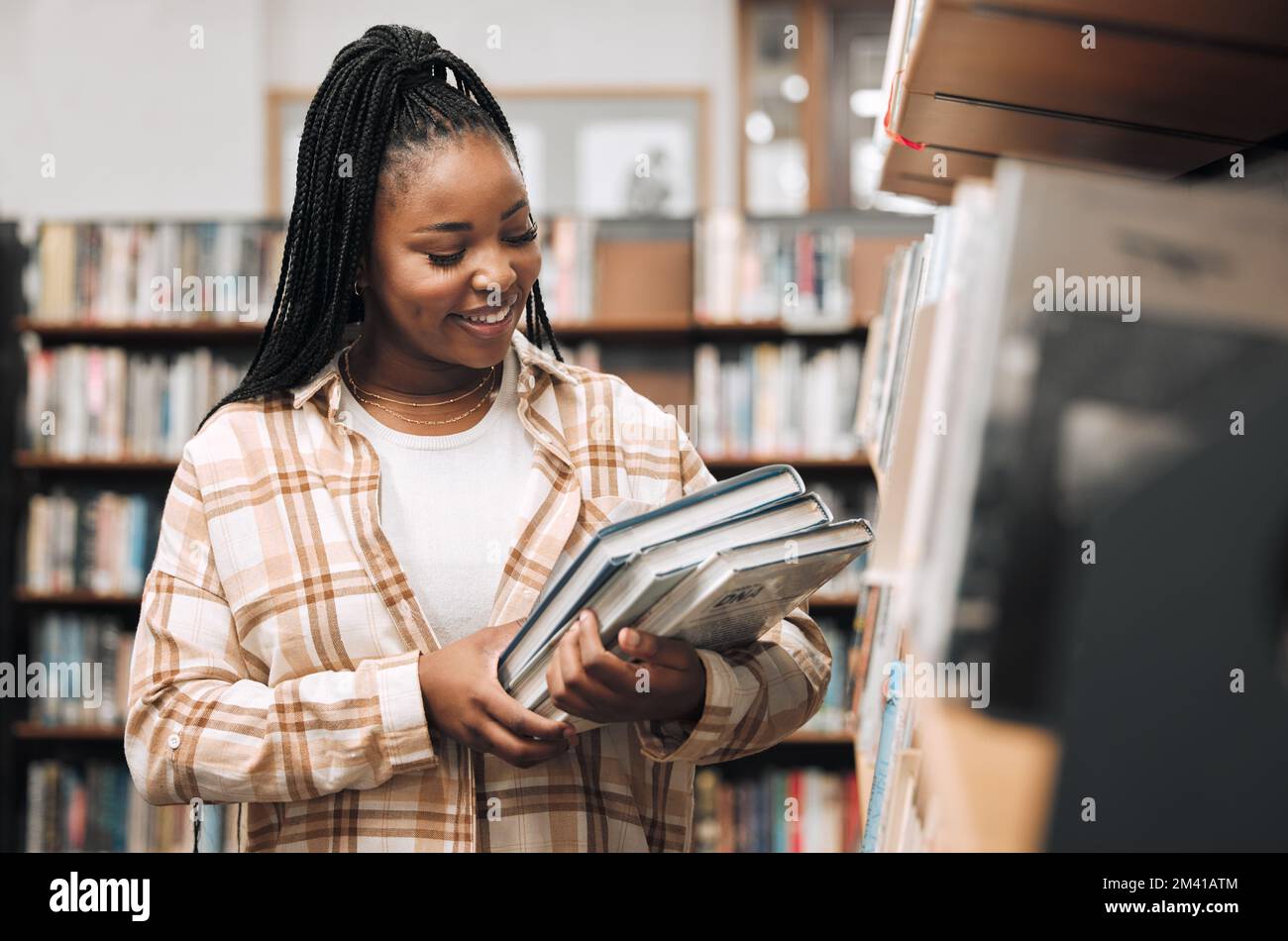 Black woman, university student and library with books for education ...