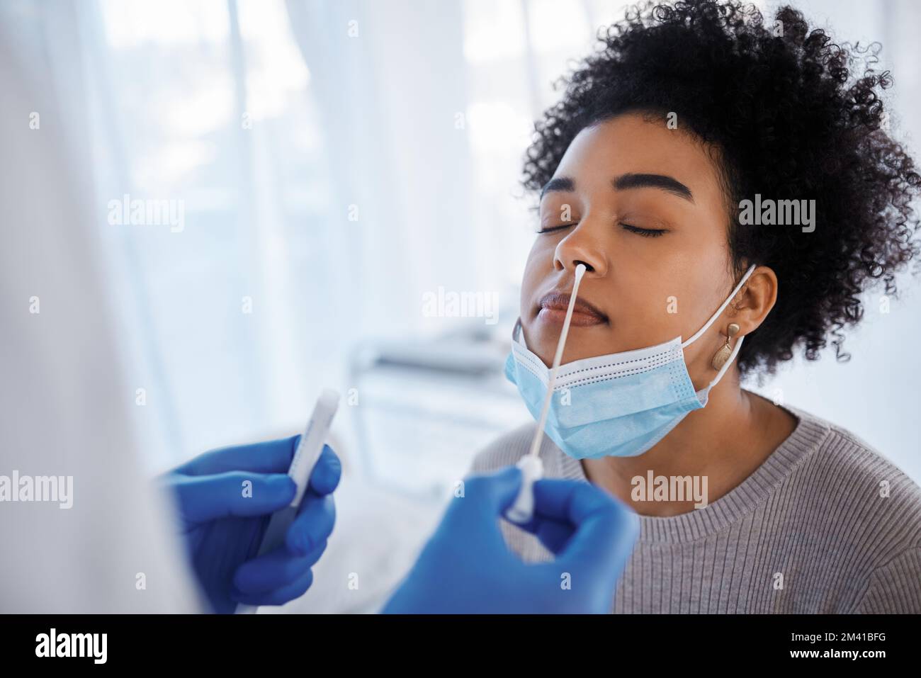 Covid, health and medical test with black woman, nasal swab and doctor ...