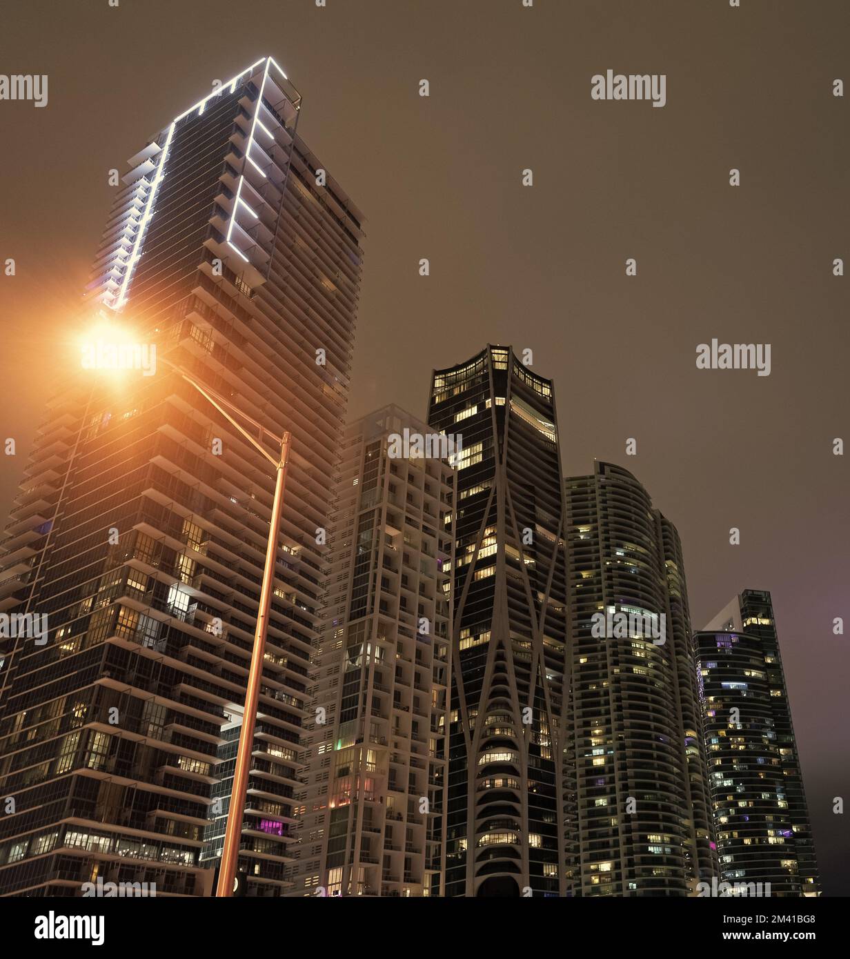 Nocturnal architecture. Skyscrapers lit up in Miami, USA. Illuminated ...