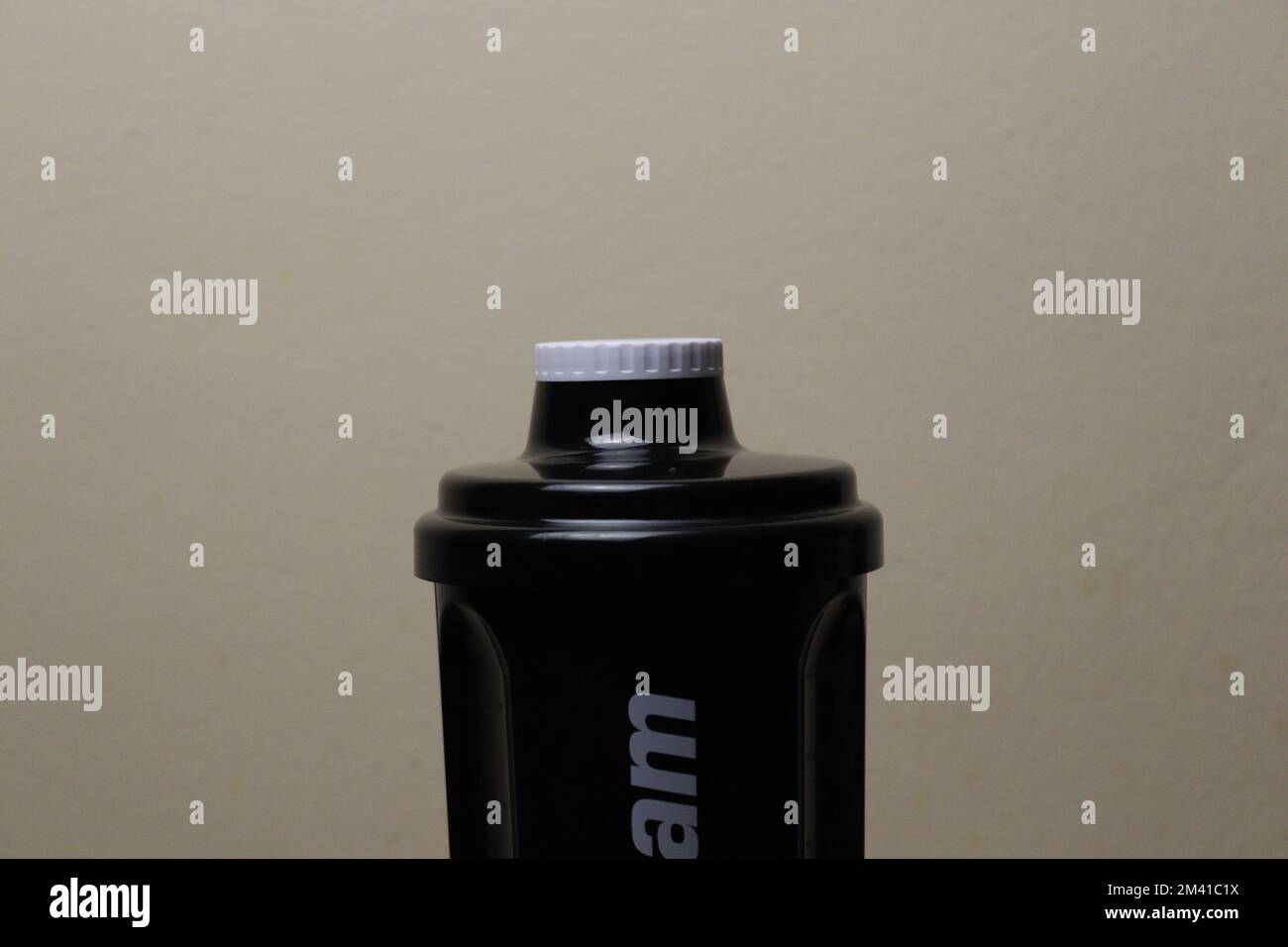 The top of a shaker that has a white cap and the colour of the ...