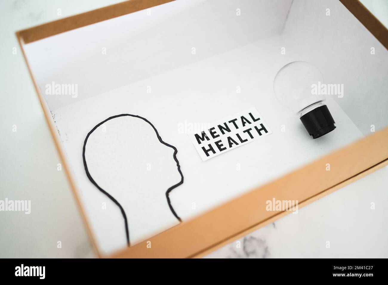 mental health text in box next to cardboard head with light bulb ...