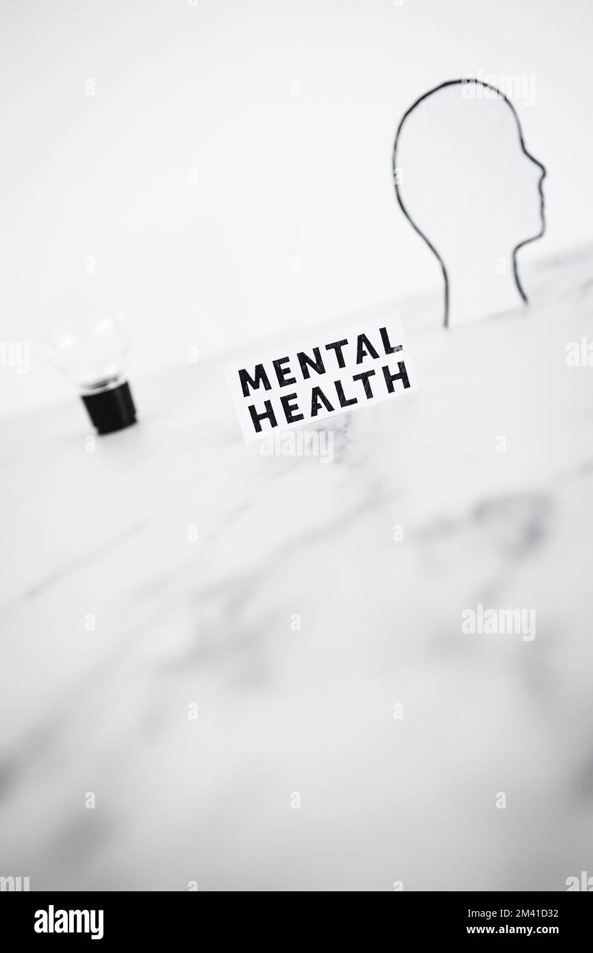 mental health text next to cardboard head with light bulb, psychology ...