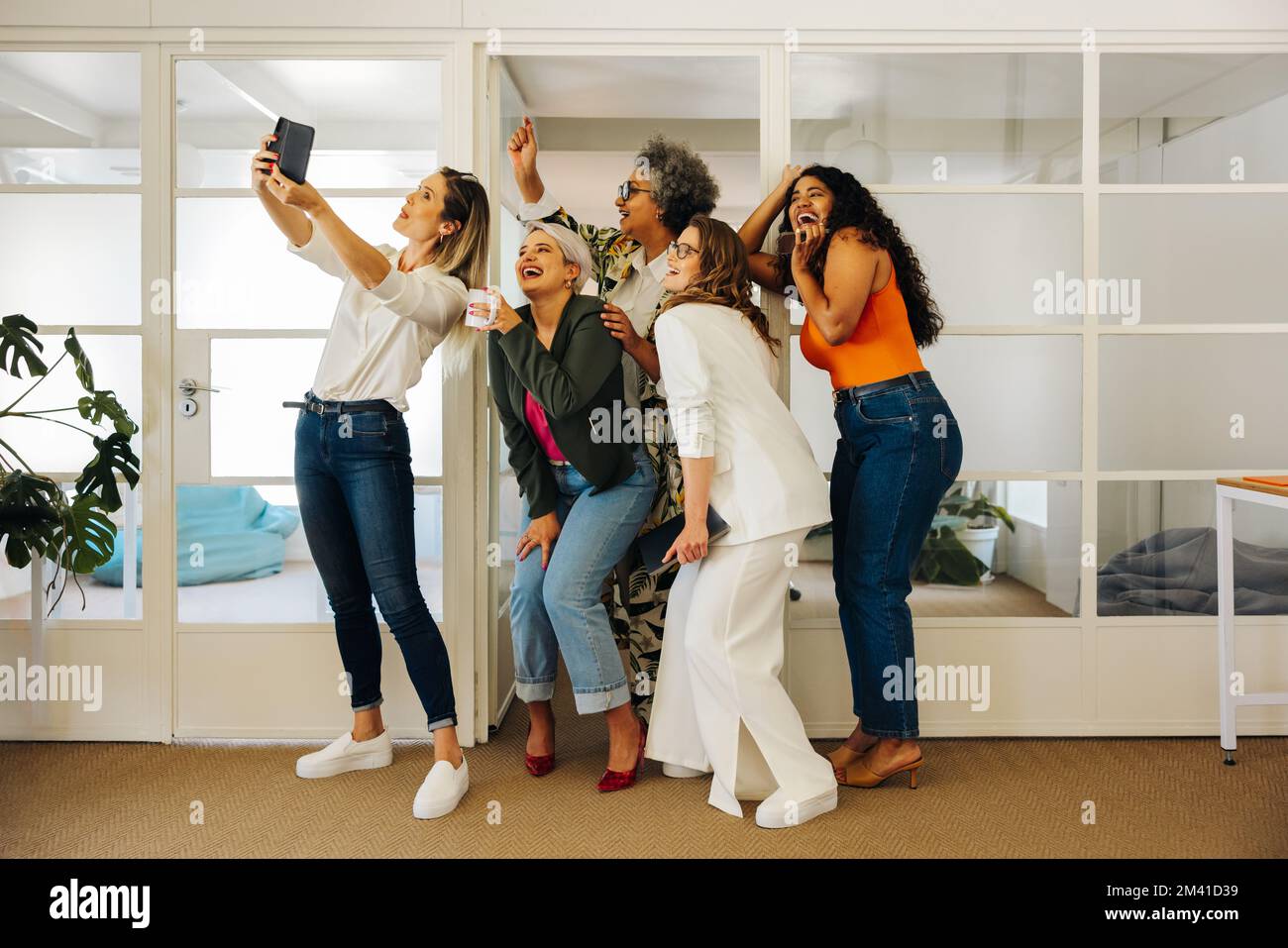 Group of happy businesspeople smiling cheerfully while taking a selfie ... Group of happy businesspeople smiling cheerfully while taking a selfie ...