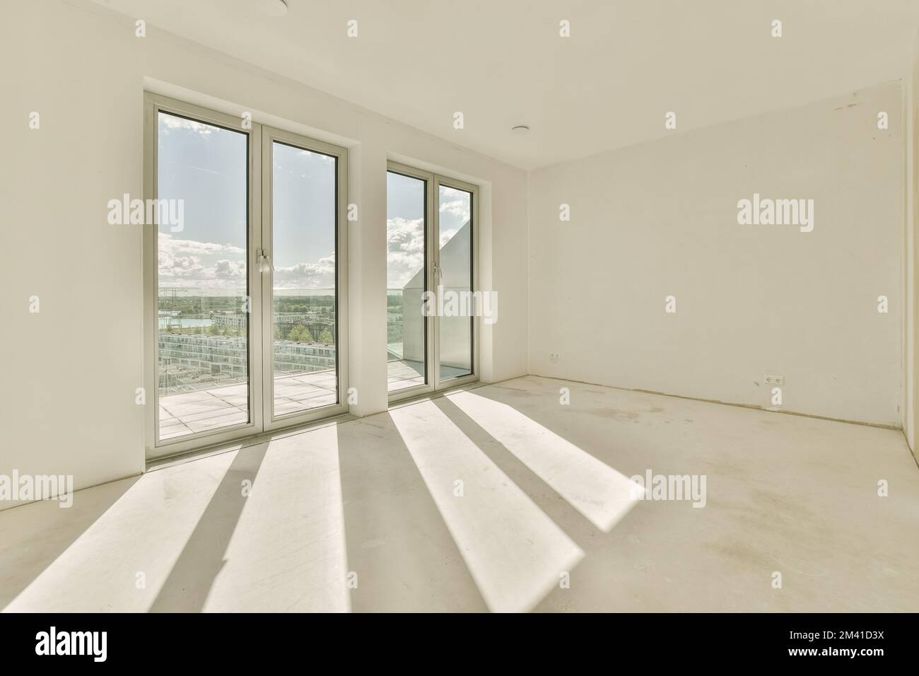 an empty room with two large windows and no one person in the photo is ...