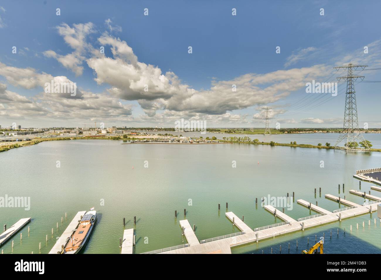 a lake with boats docked on the water and power lines in the distance ...