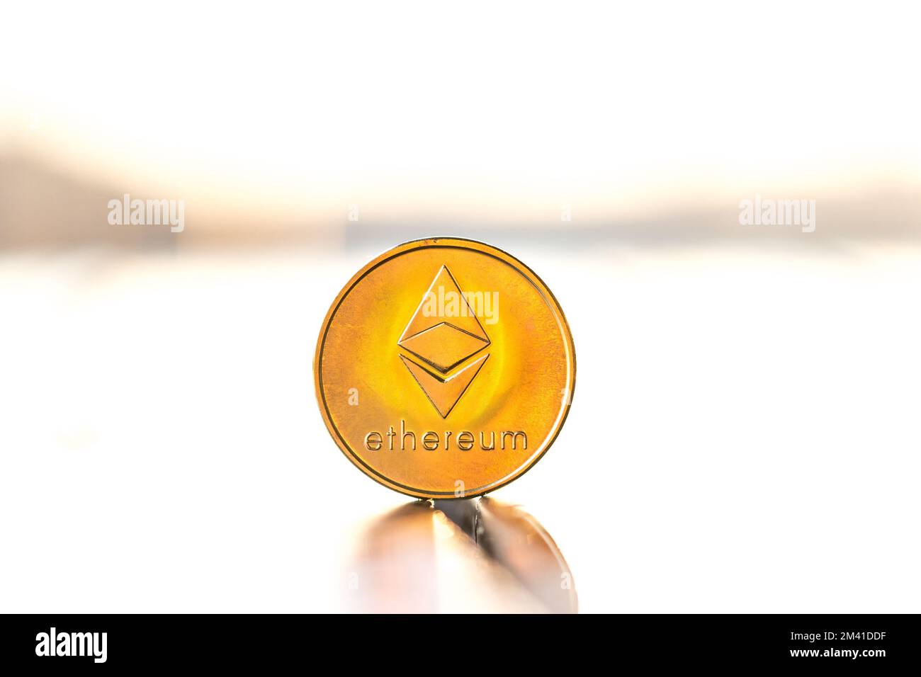 Ethereum gold color coin with sunset white background. Cryptocurrency ...