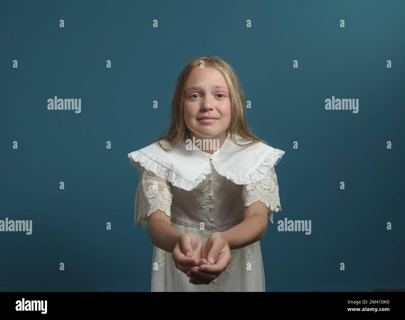 Need help child. Unhappy young girl with long hair and tear drop on ...