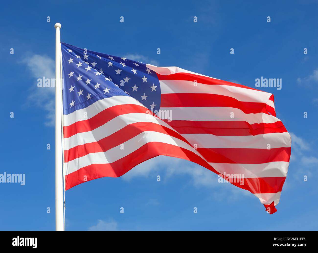 large american flag with stars and stripes flying in the blue sky Stock ...