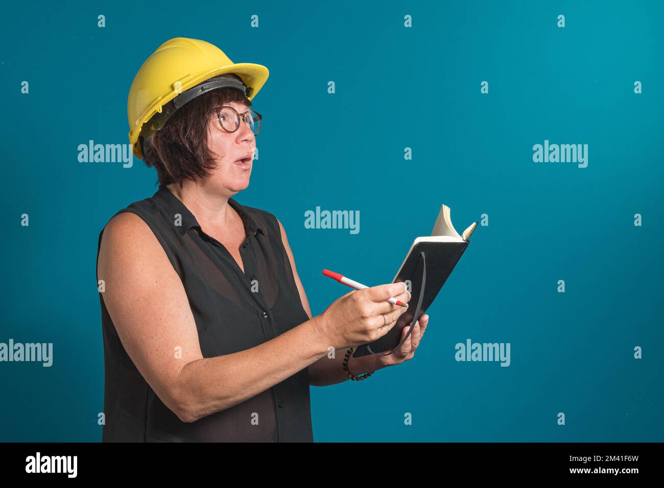 Surprised woman inspector at a construction site Stock Photo - Alamy