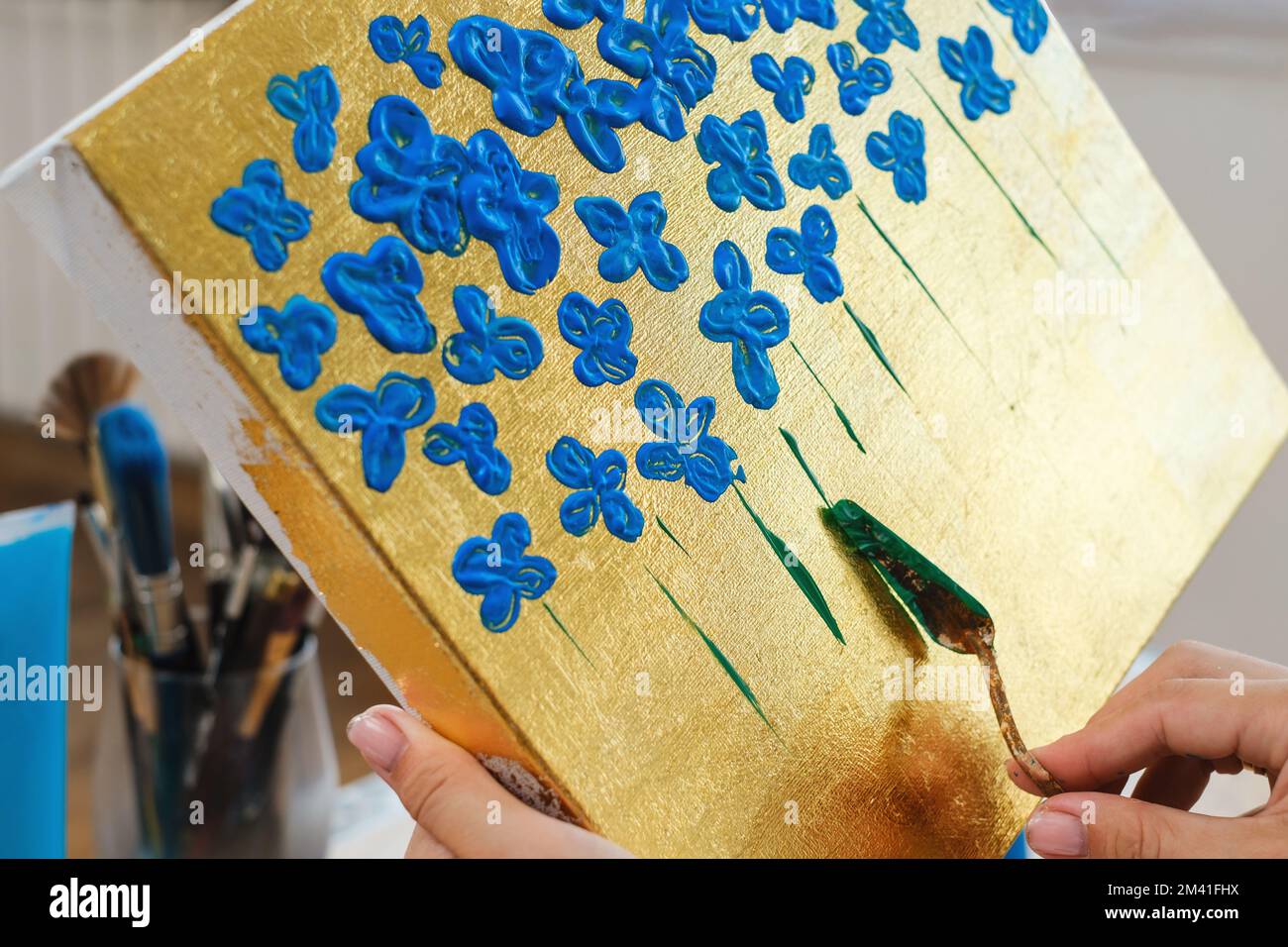 Painter hand with spatula, close-up art work with oil paints. Artist ...