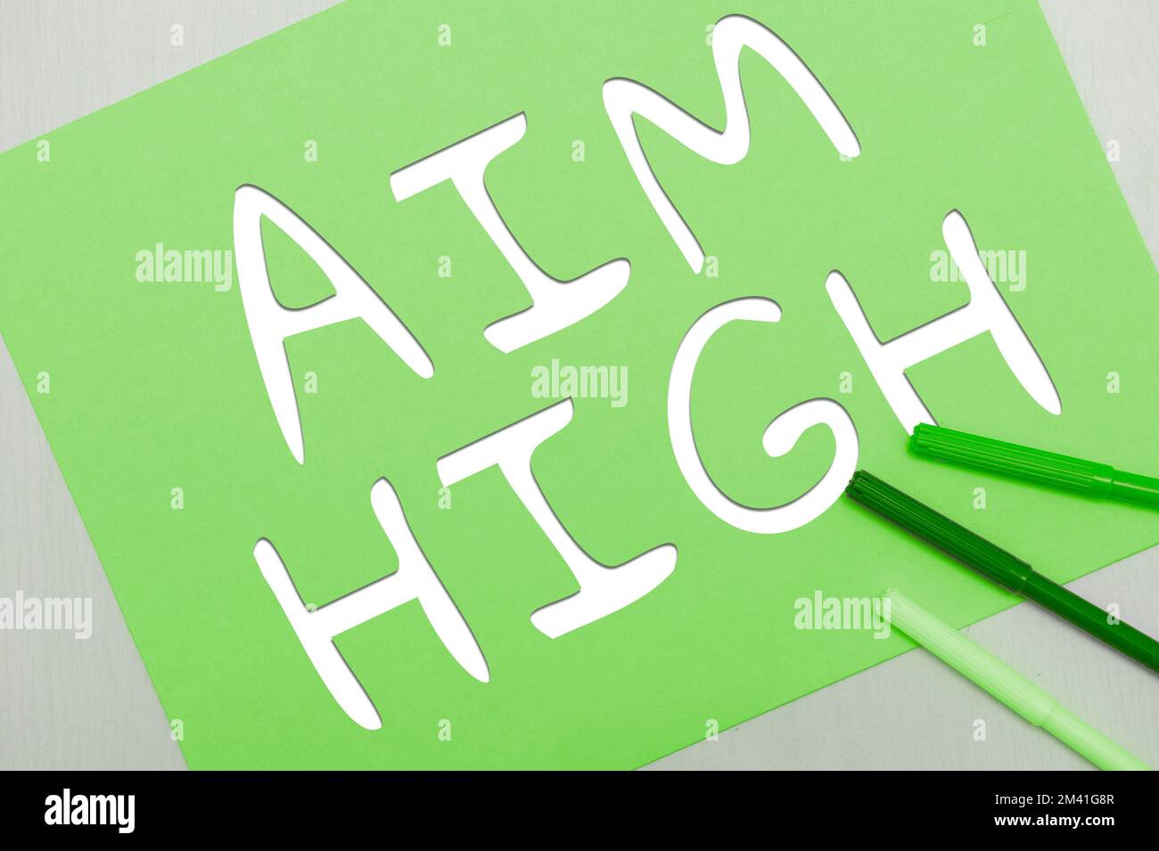 Sign displaying Aim High. Concept meaning go for best job school or ...